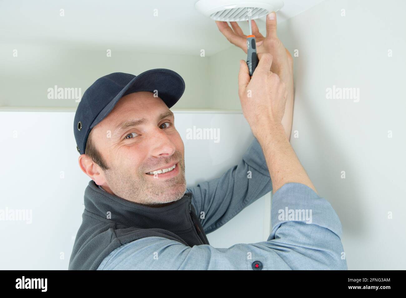 handsome man fixing ceiling panels Stock Photo - Alamy