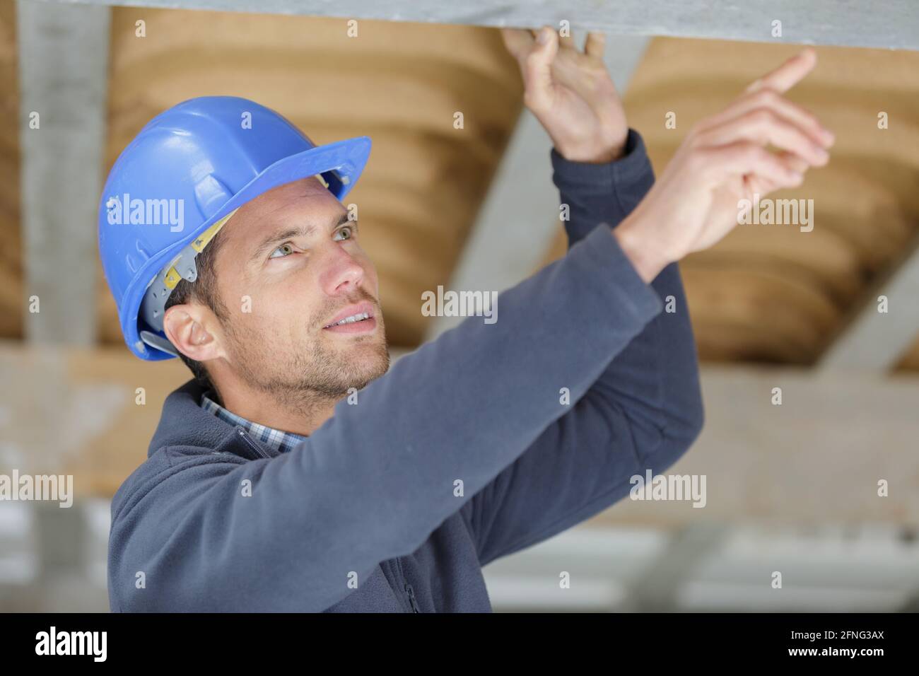 male engineer pointing at ceiling Stock Photo - Alamy