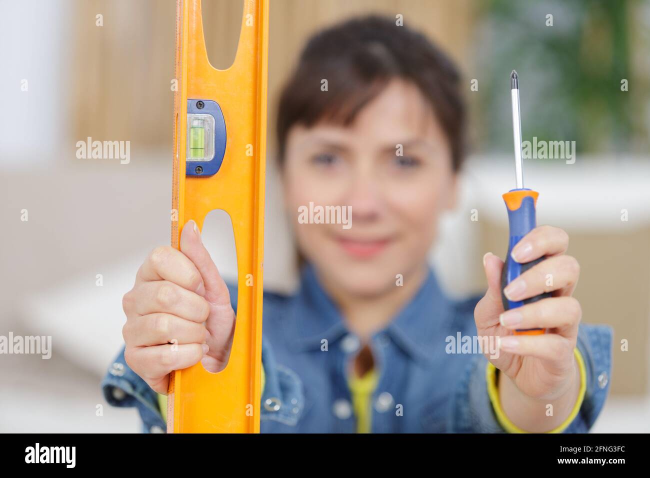 a woman showing diy tools Stock Photo - Alamy