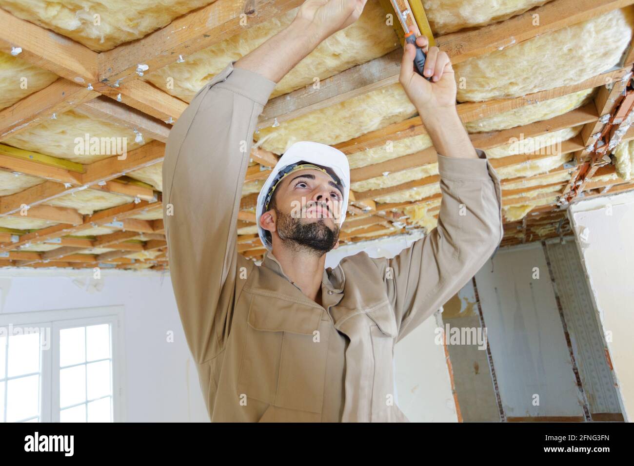 man and construction ceiling works Stock Photo - Alamy