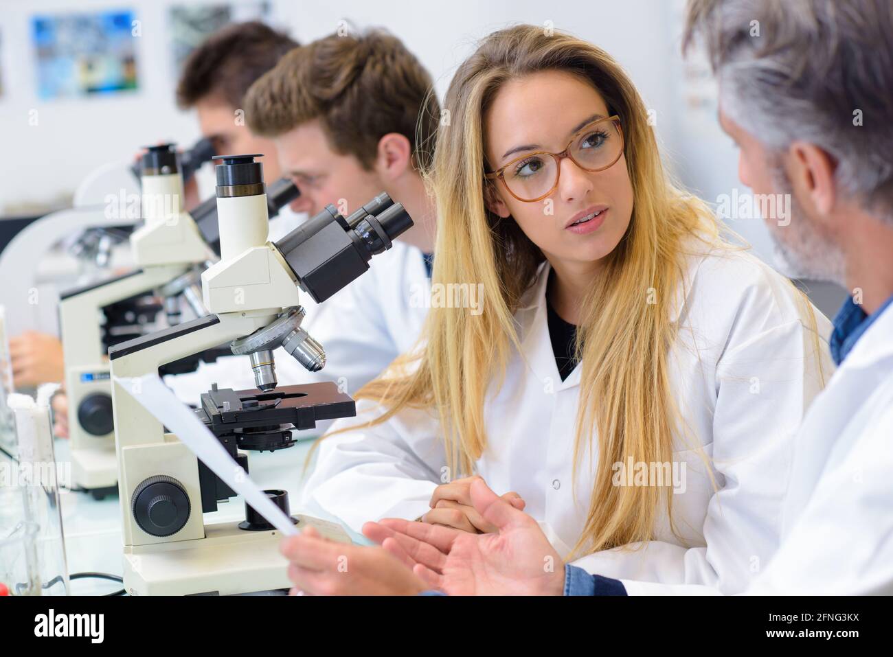 student and teacher science discussion Stock Photo - Alamy