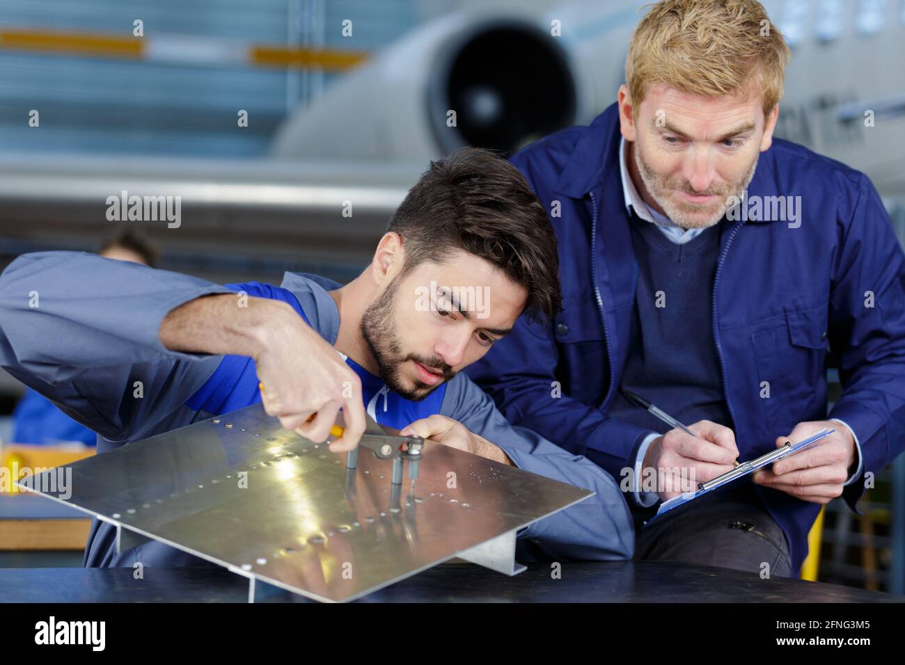 supervisor observing how a worker works Stock Photo - Alamy