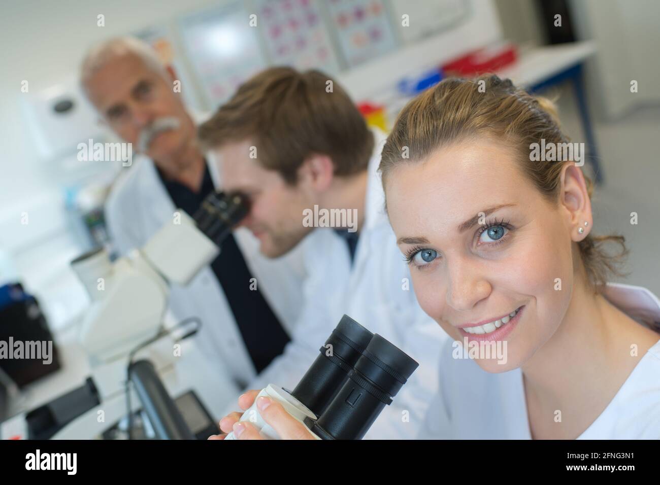 Woman looking into microscope eyepiece hi-res stock photography and ...