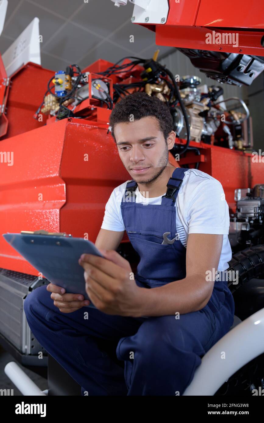 car mechanic checking a car engine Stock Photo - Alamy