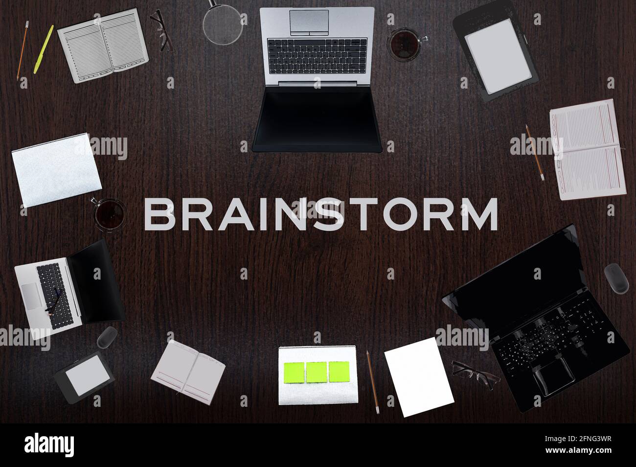 Brainstorm concept. Top layout of drawings of laptops, notepads, coffee ...