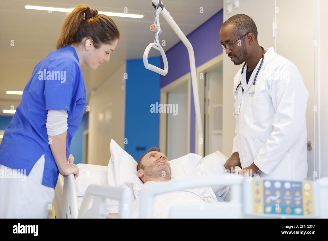 smiling woman and doctor on hospital bed transporting a patient Stock ...