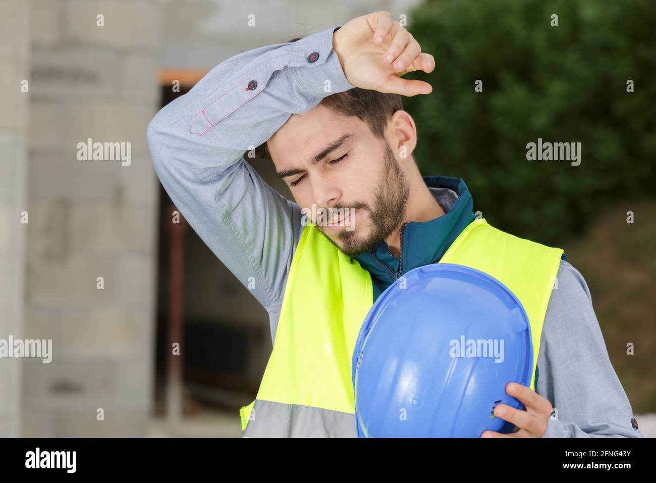 a tired young man builder Stock Photo - Alamy