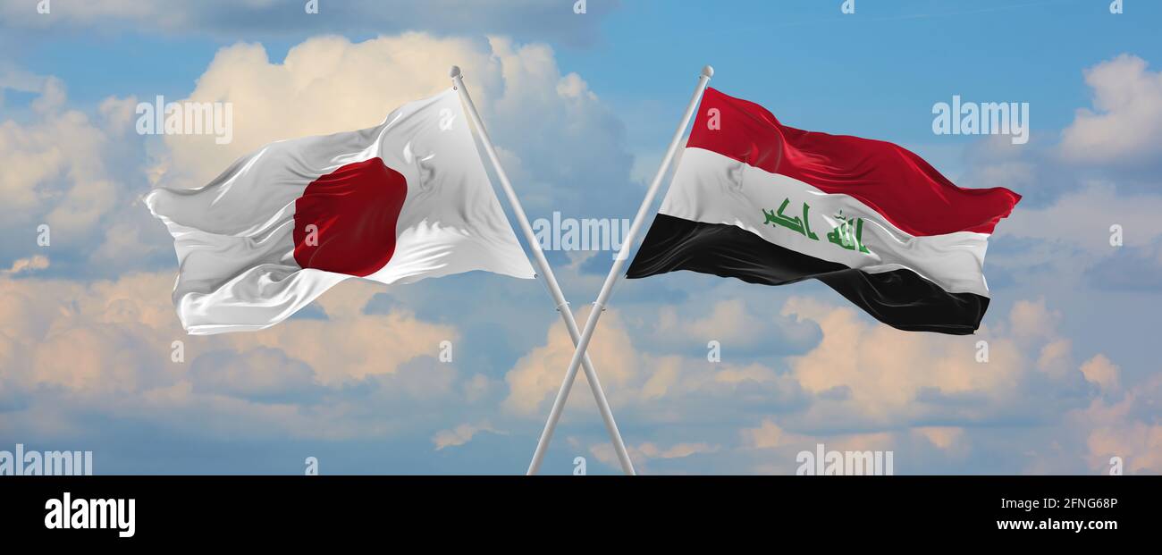 flags of Japan and Iraq waving in the wind on flagpoles against sky ...