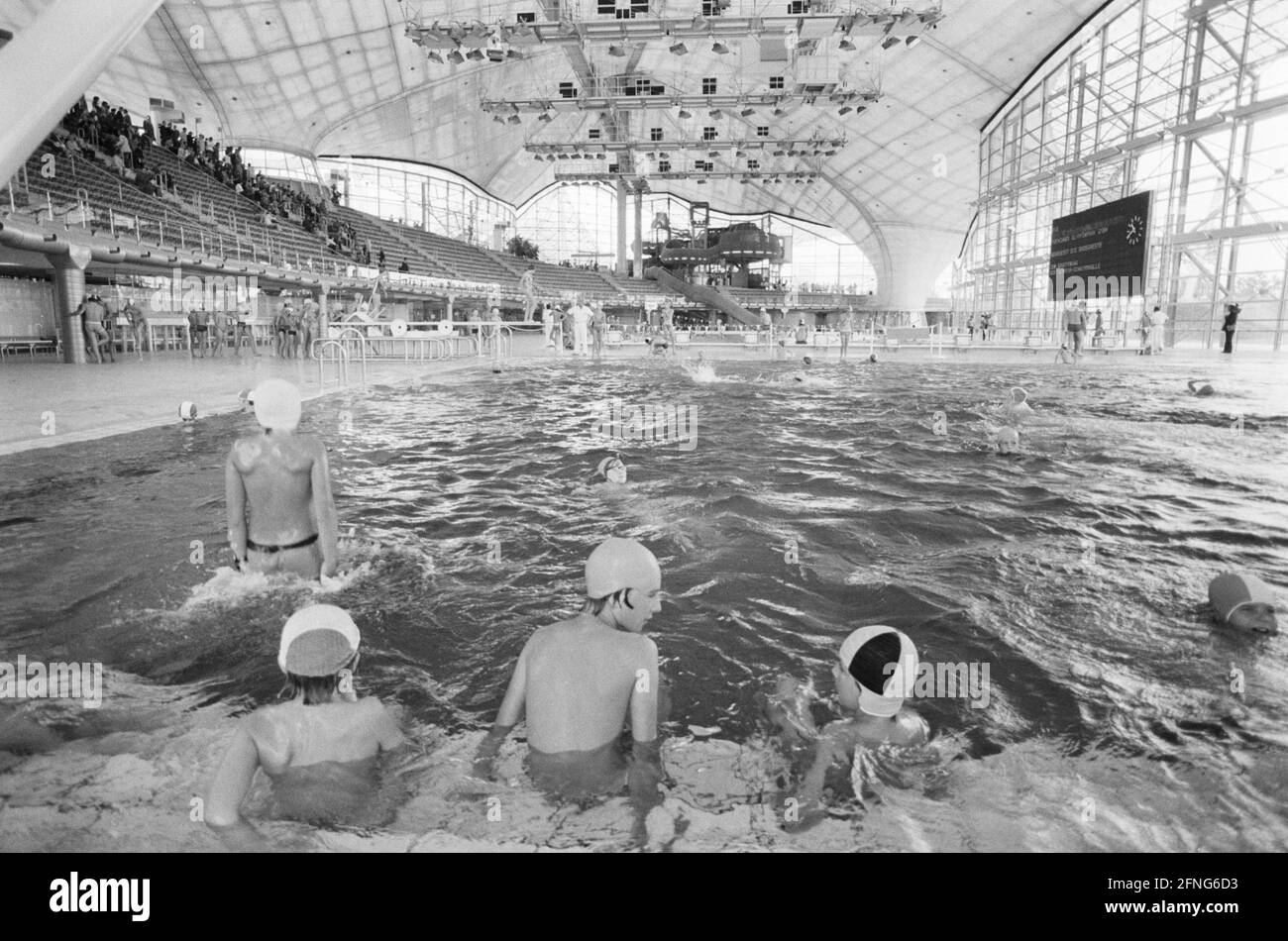 Boys sit poolside in the water of the Olympic Swimming Hall, which ...