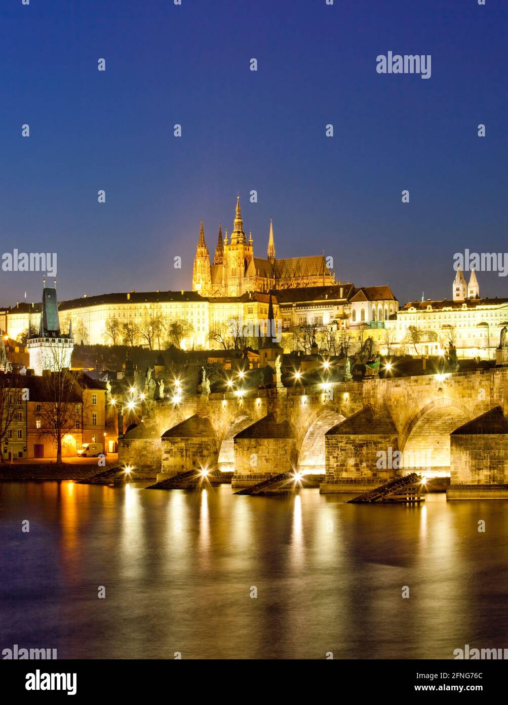 Prague, Czechia. Hradcany castle and Charles bridge at dusk Stock Photo ...