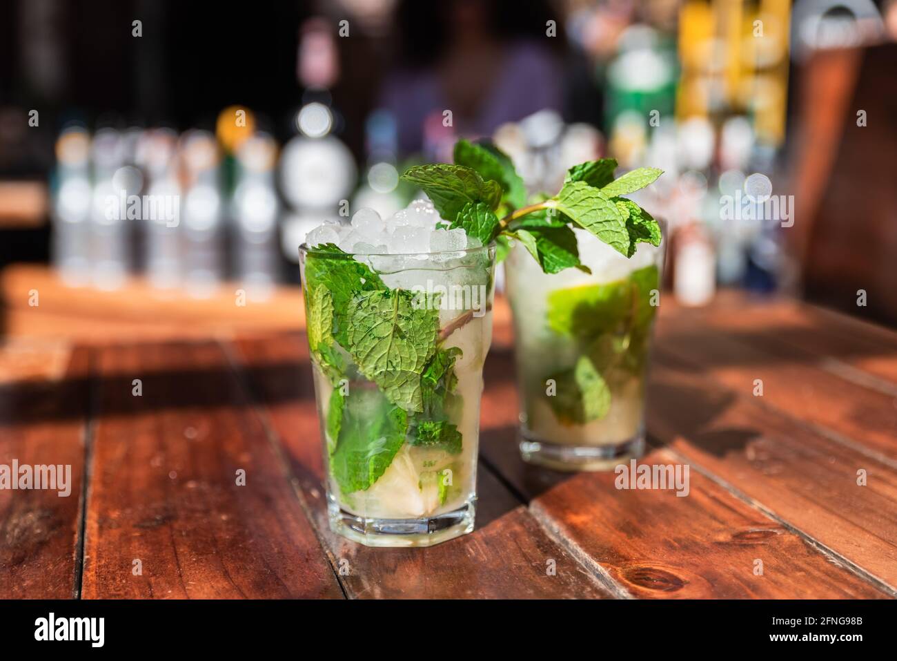 Glasses of refreshing mojito cocktails with ice and mint served on ...