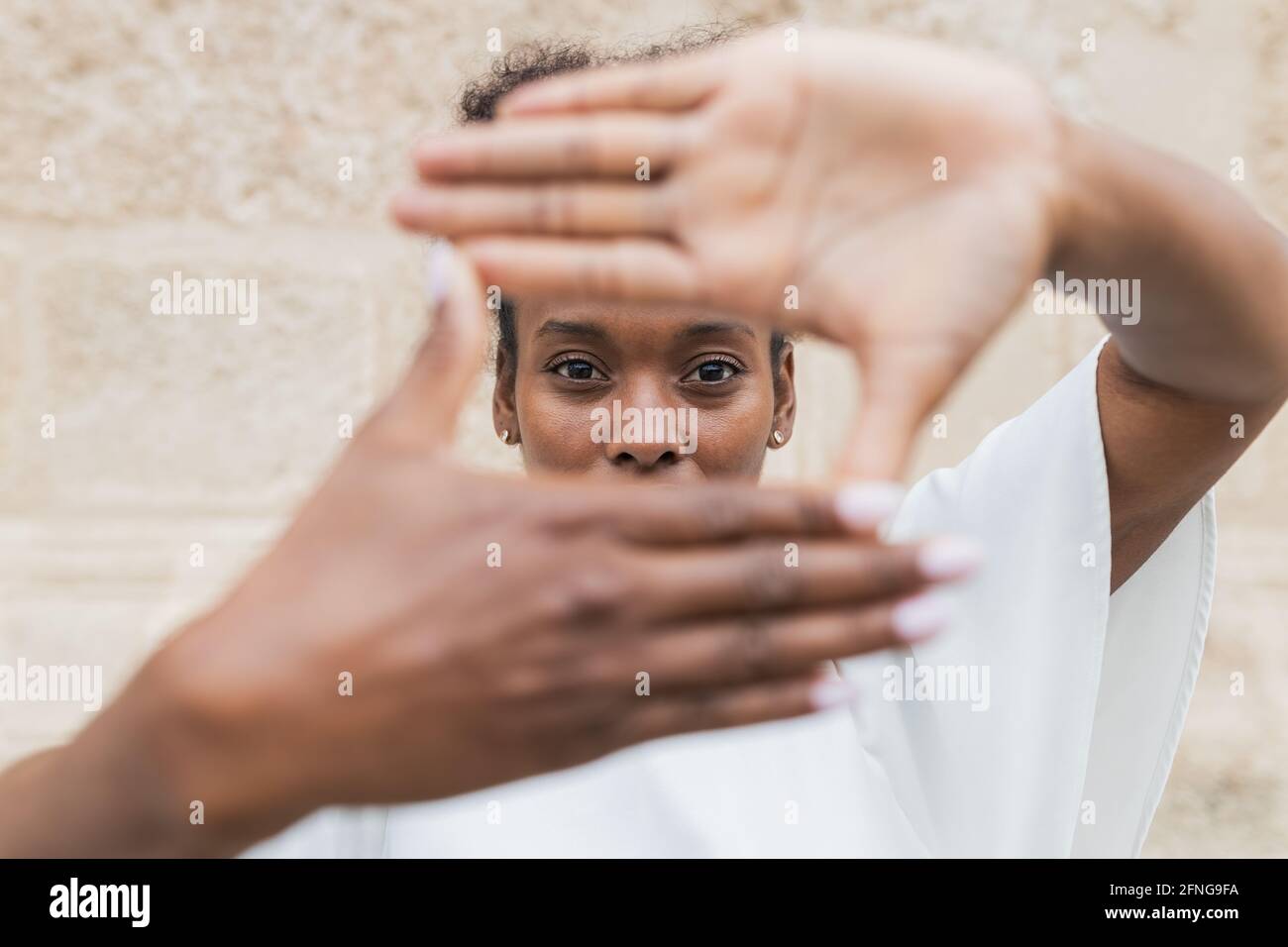 Excited young woman framing hi-res stock photography and images - Alamy