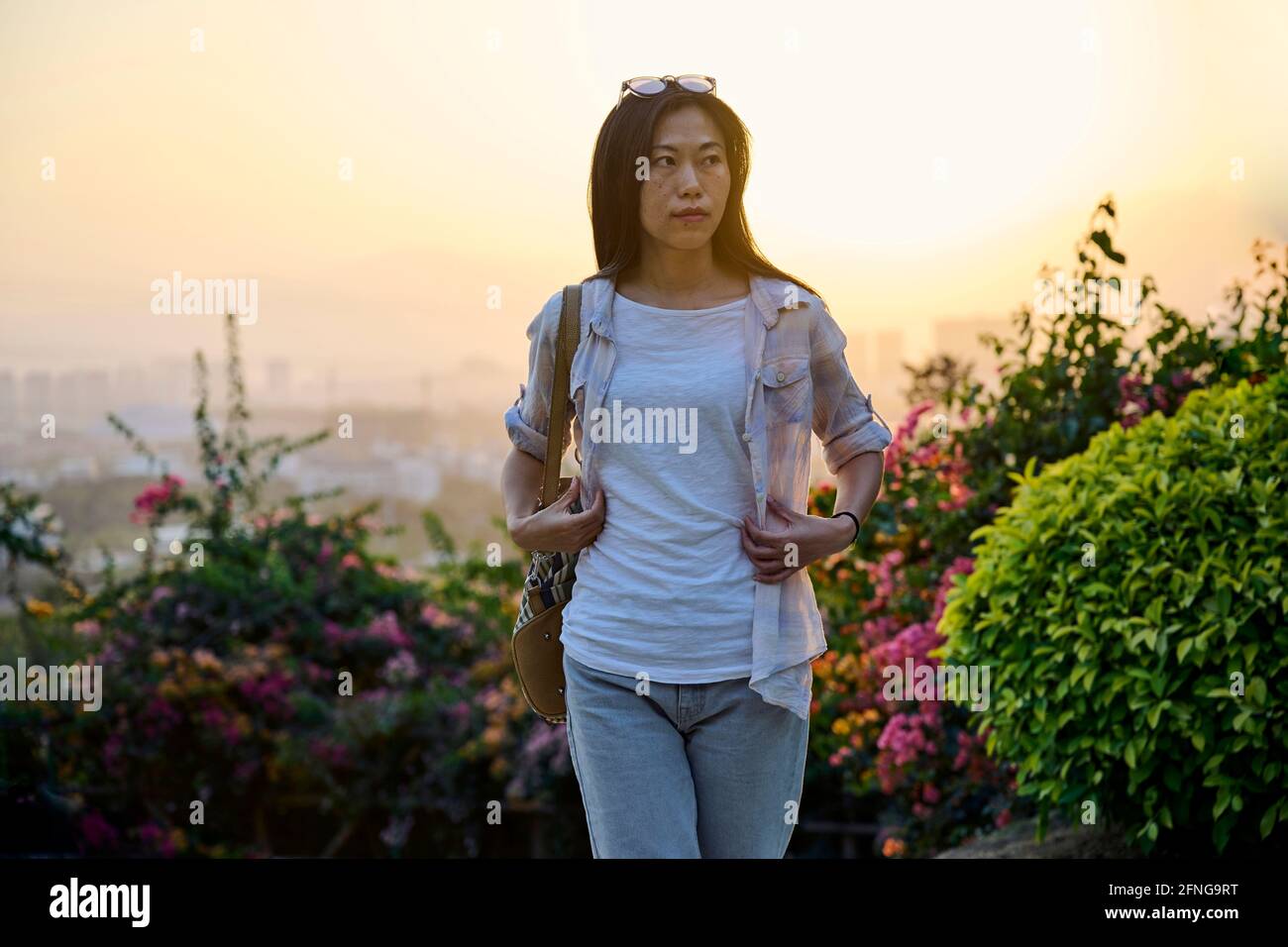 Ethnic Asian Woman walking in garden during sunset time Stock Photo - Alamy