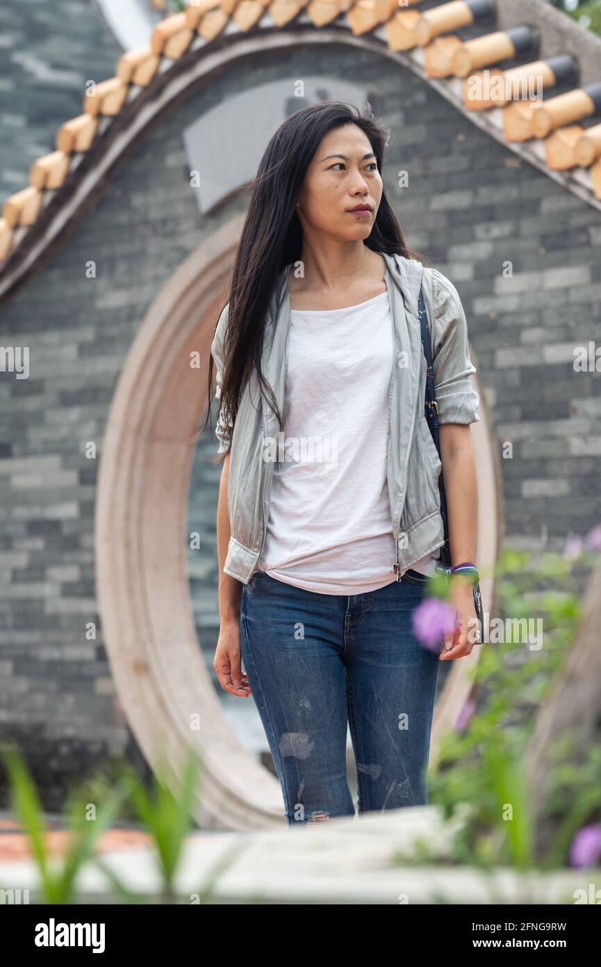 Beautiful Asian Woman walking near traditional architecture building in ...