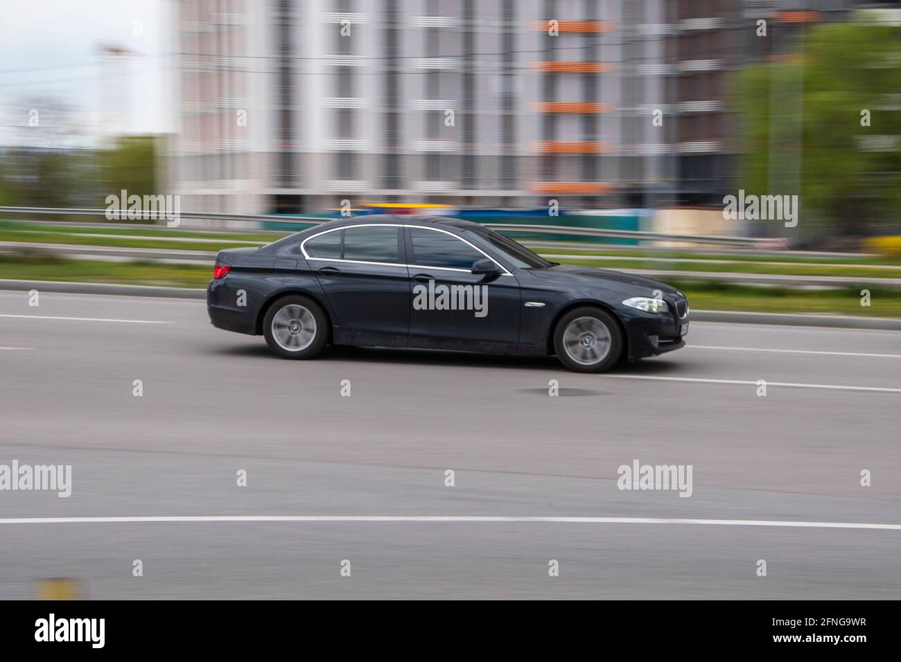 Ukraine, Kyiv - 26 April 2021: Black BMW 5 Series car moving on the ...
