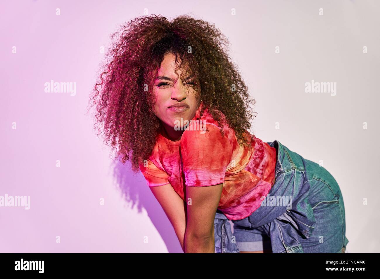 Fit African American female dancer in shorts dancing looking at camera ...