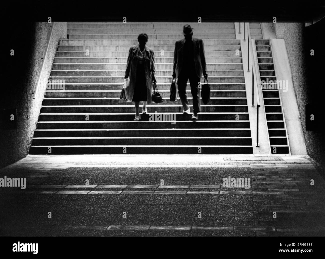 Couple descending stairs Black and White Stock Photos & Images - Alamy