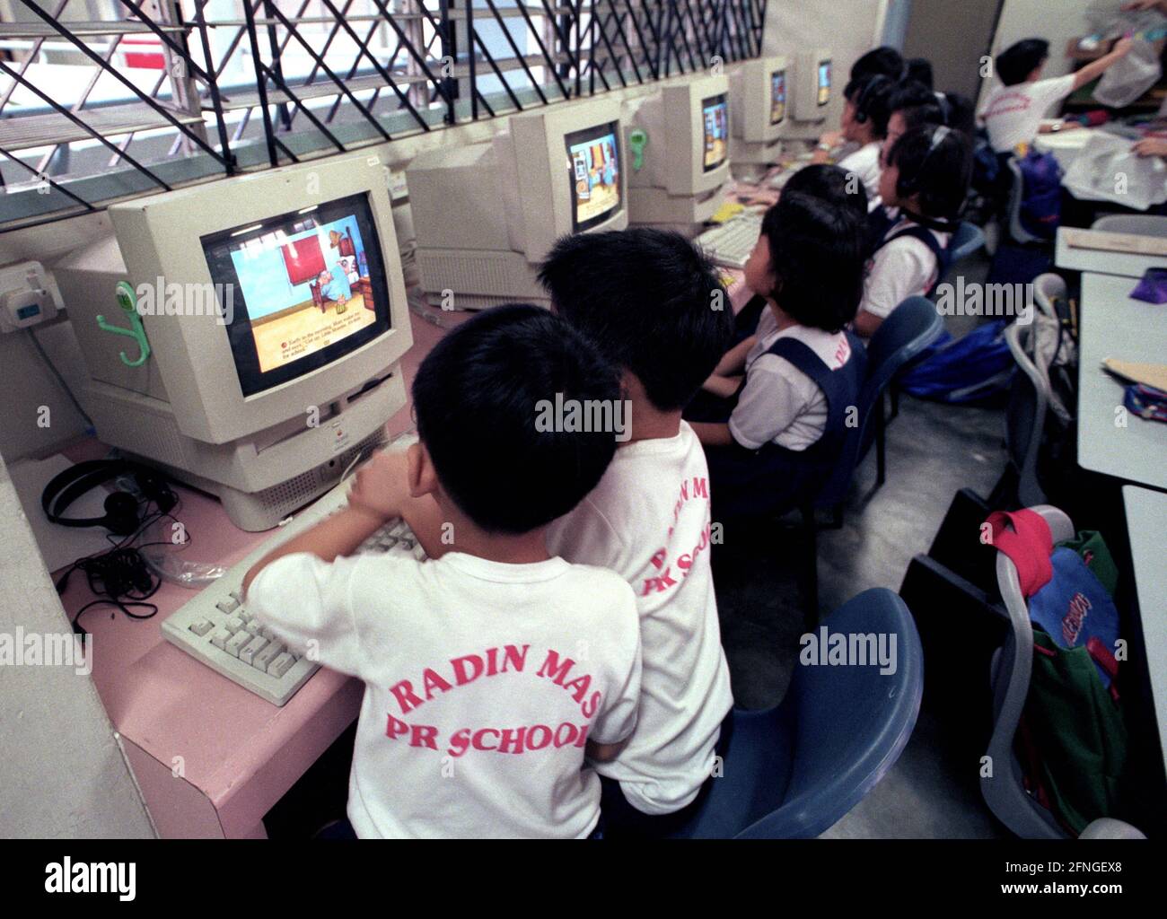 SGP , Singapore : Children learning with computers at Radin Mas School ...
