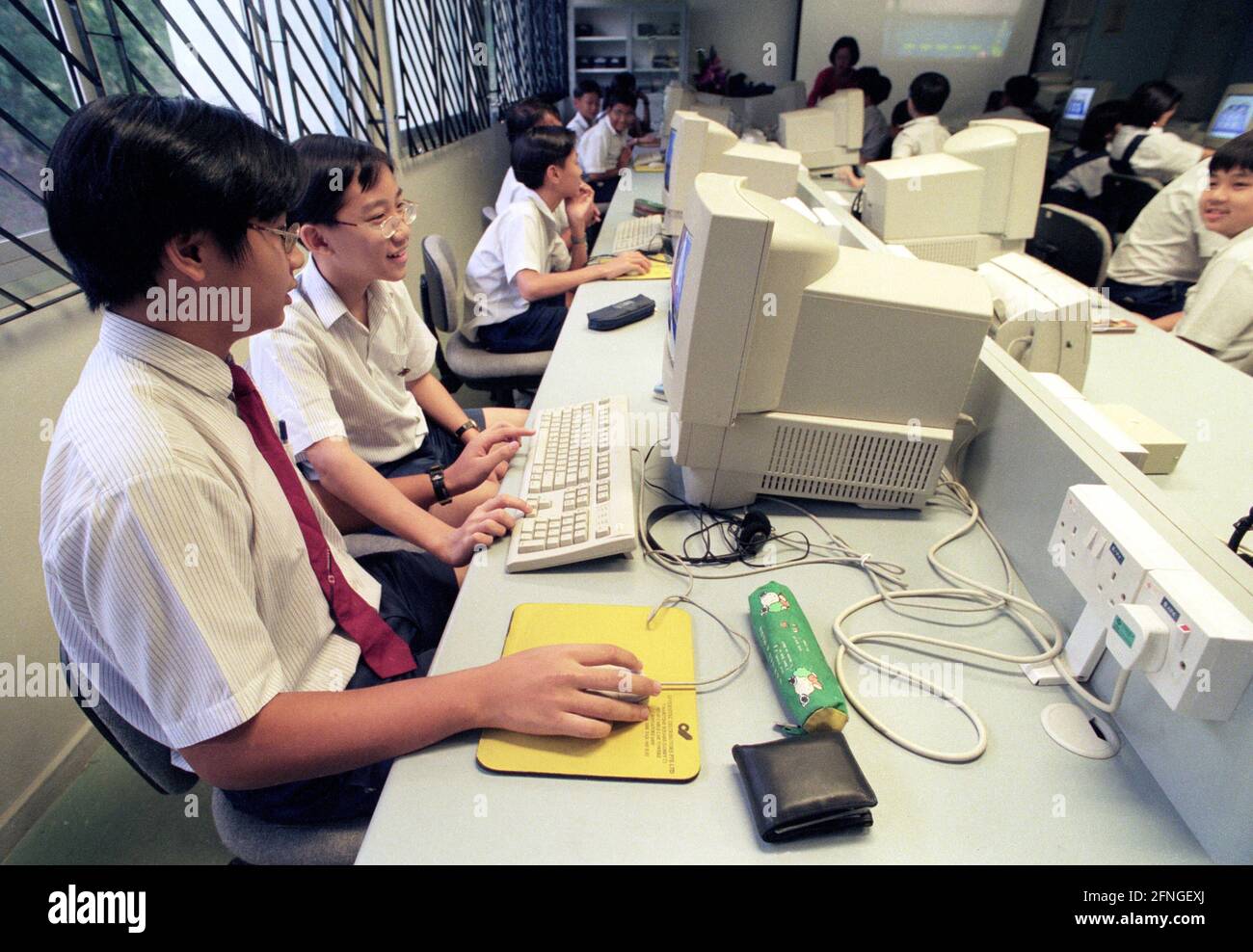 SGP , Singapore : Children learning with computers at Radin Mas School ...
