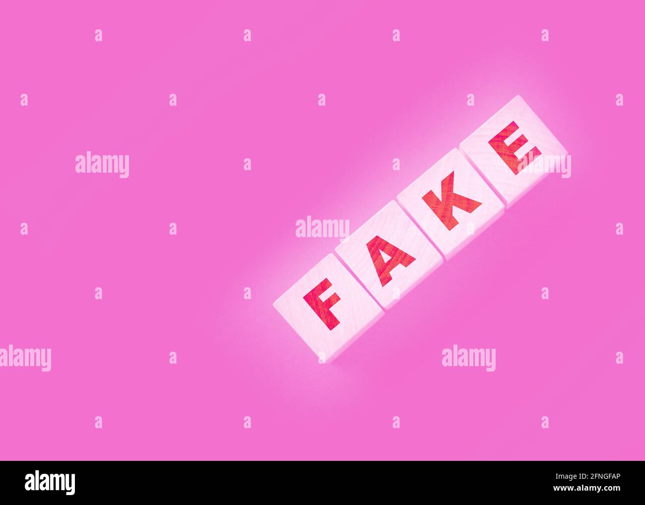 FAKE word written in wooden blocks on black background Stock Photo - Alamy