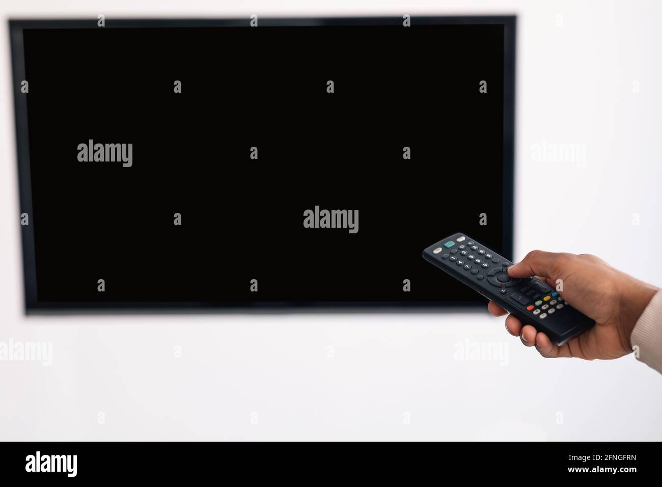 Watching tv using remote controller hi-res stock photography and images ...