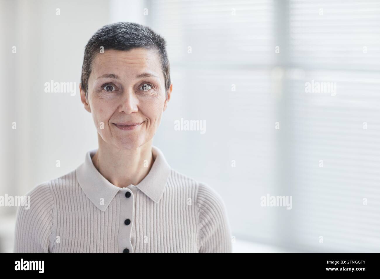 Portrait of smiling mature woman looking at camera Stock Photo - Alamy