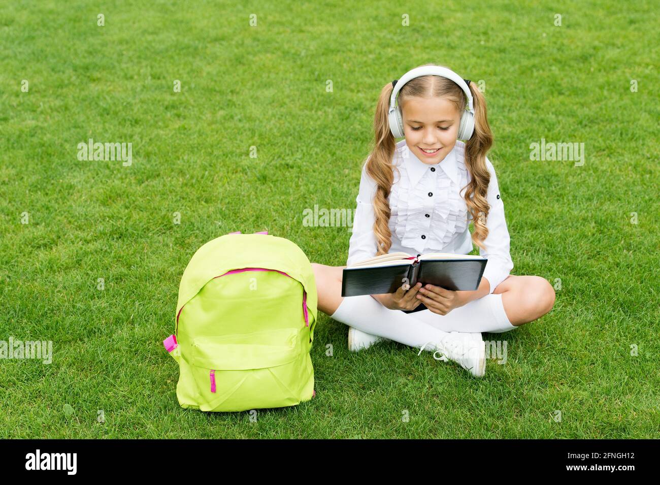 Language learning course. Girl child learn English sitting on green ...