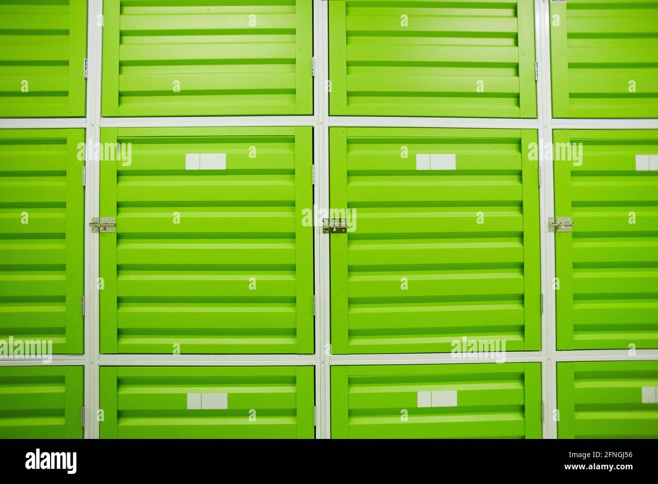 Close-up of green storage boxes in warehouse Stock Photo - Alamy