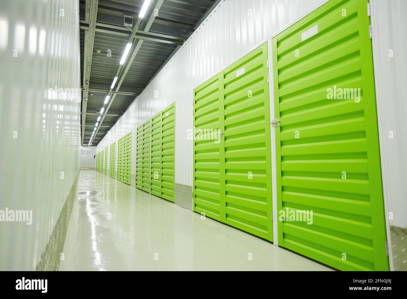 Image of storage green boxes in warehouse Stock Photo - Alamy