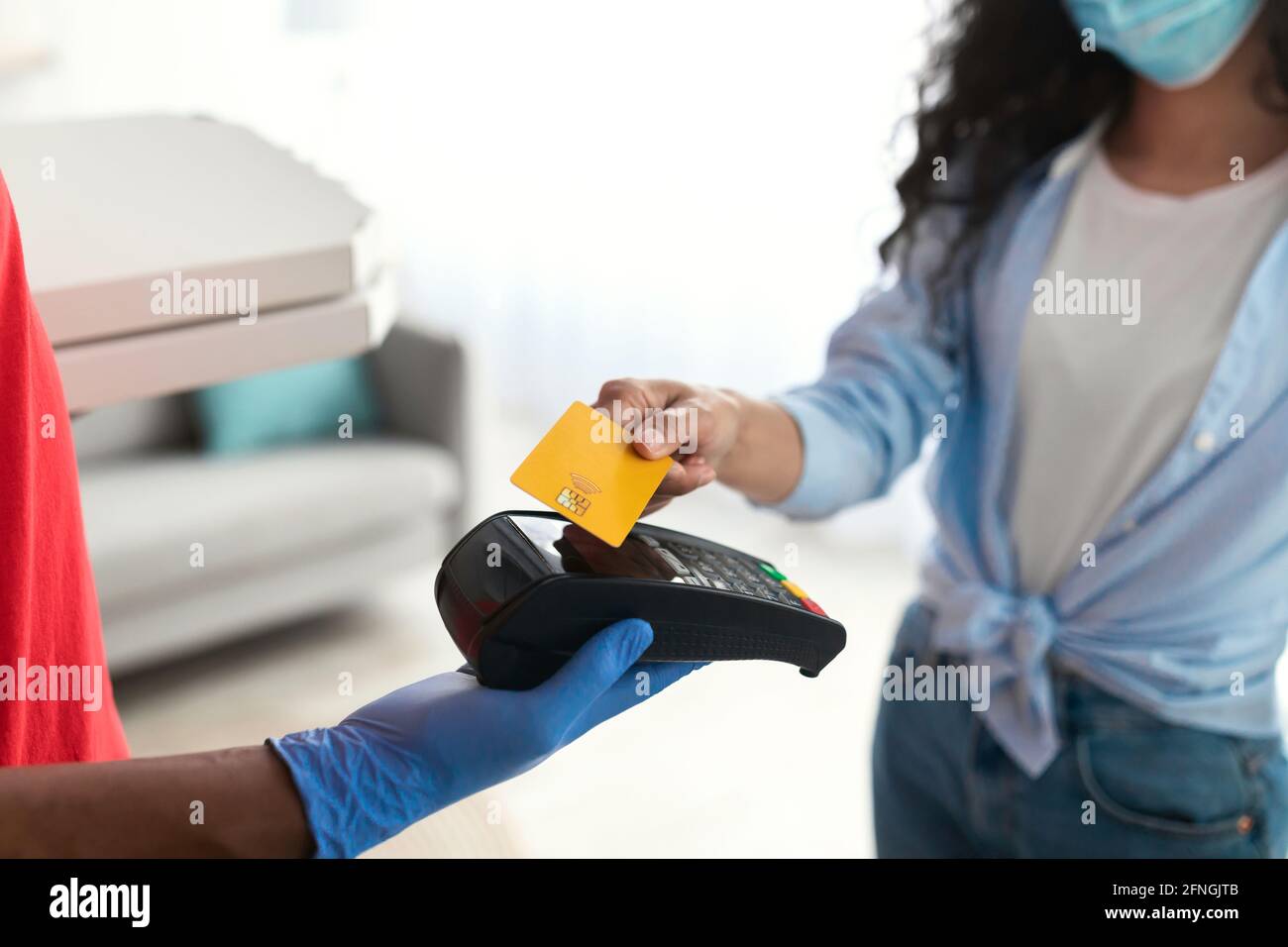 Portrait of black man holding POS machine for payment Stock Photo - Alamy