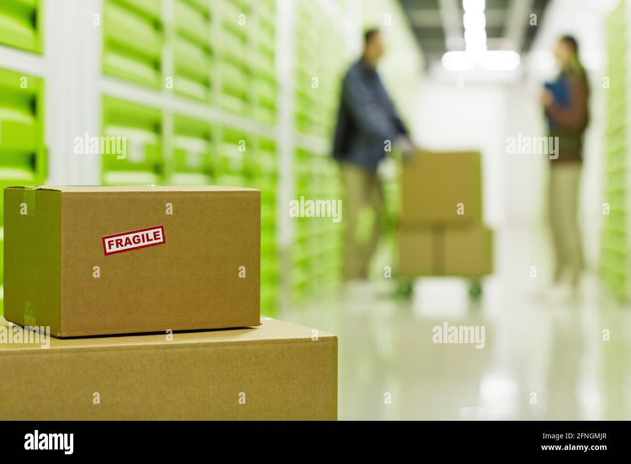 Two men carrying cardboard box hi-res stock photography and images - Alamy