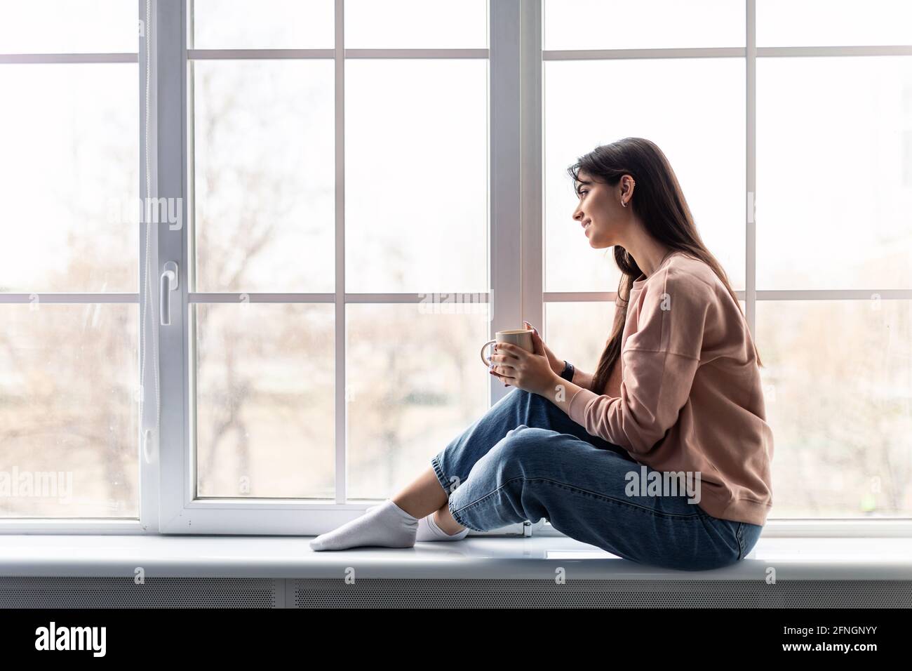 Woman having rest at home on the weekend drinking coffee Stock Photo ...