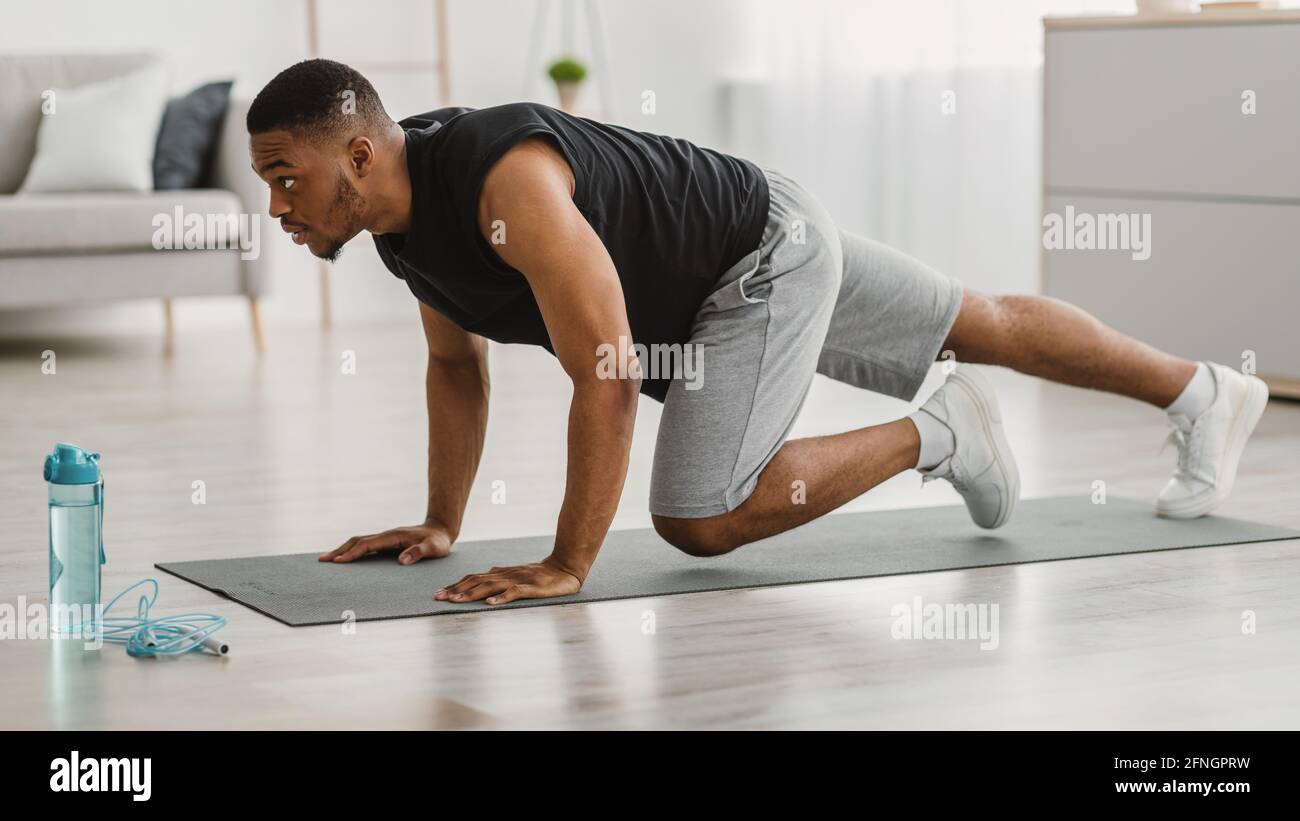 Sporty African Man Doing Running Plank Exercise At Home, Side-View ...