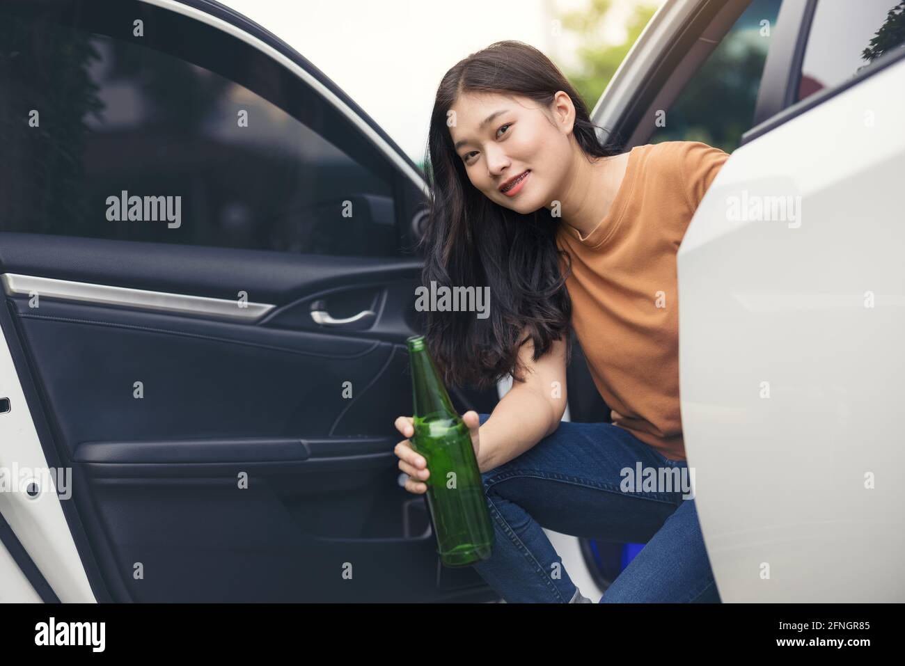 Drinking a beer from Bottle in the car, Girls drink alcohol Stock Photo ...