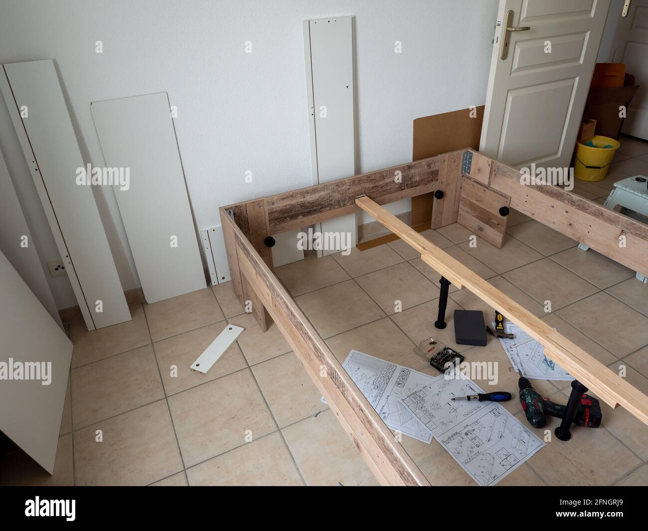 furniture - assembling the bed, lying tools and wooden elements needed ...