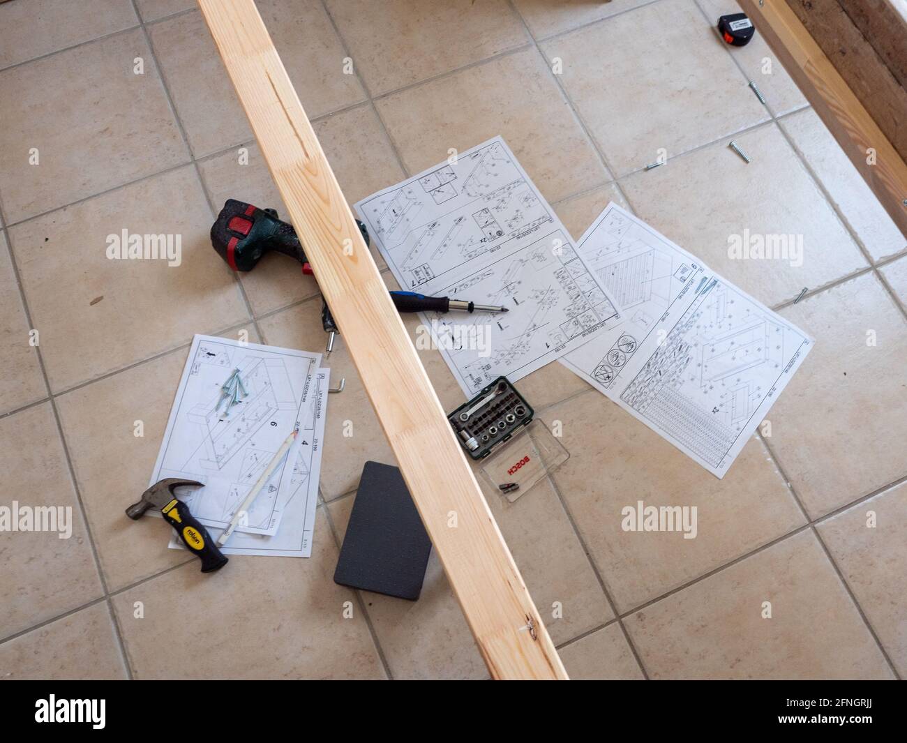 furniture - assembling the bed, lying tools and wooden elements needed ...