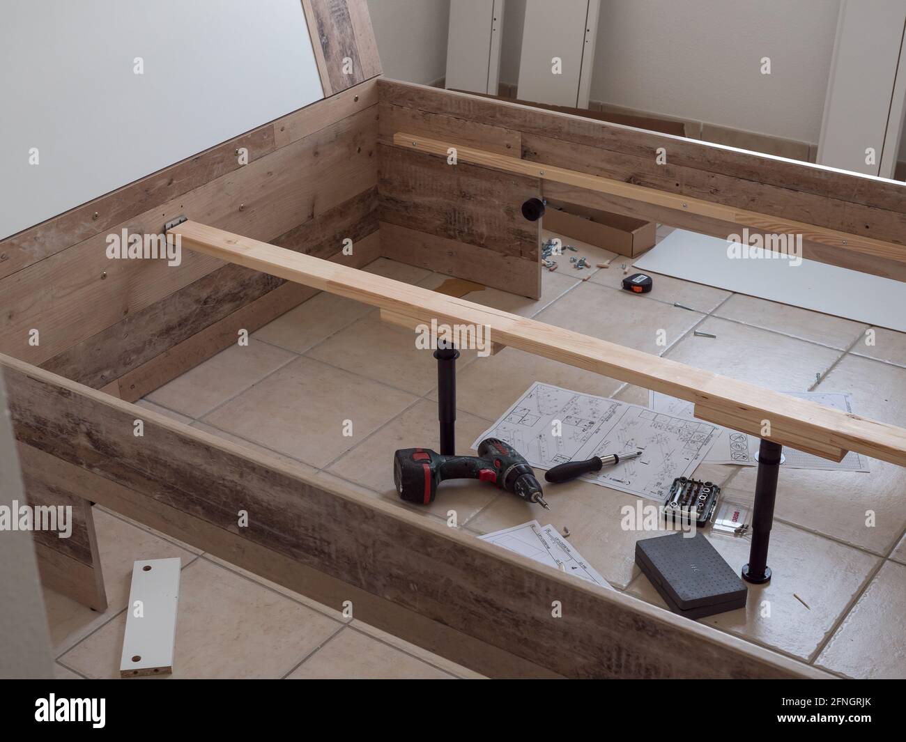 furniture - assembling the bed, lying tools and wooden elements needed ...