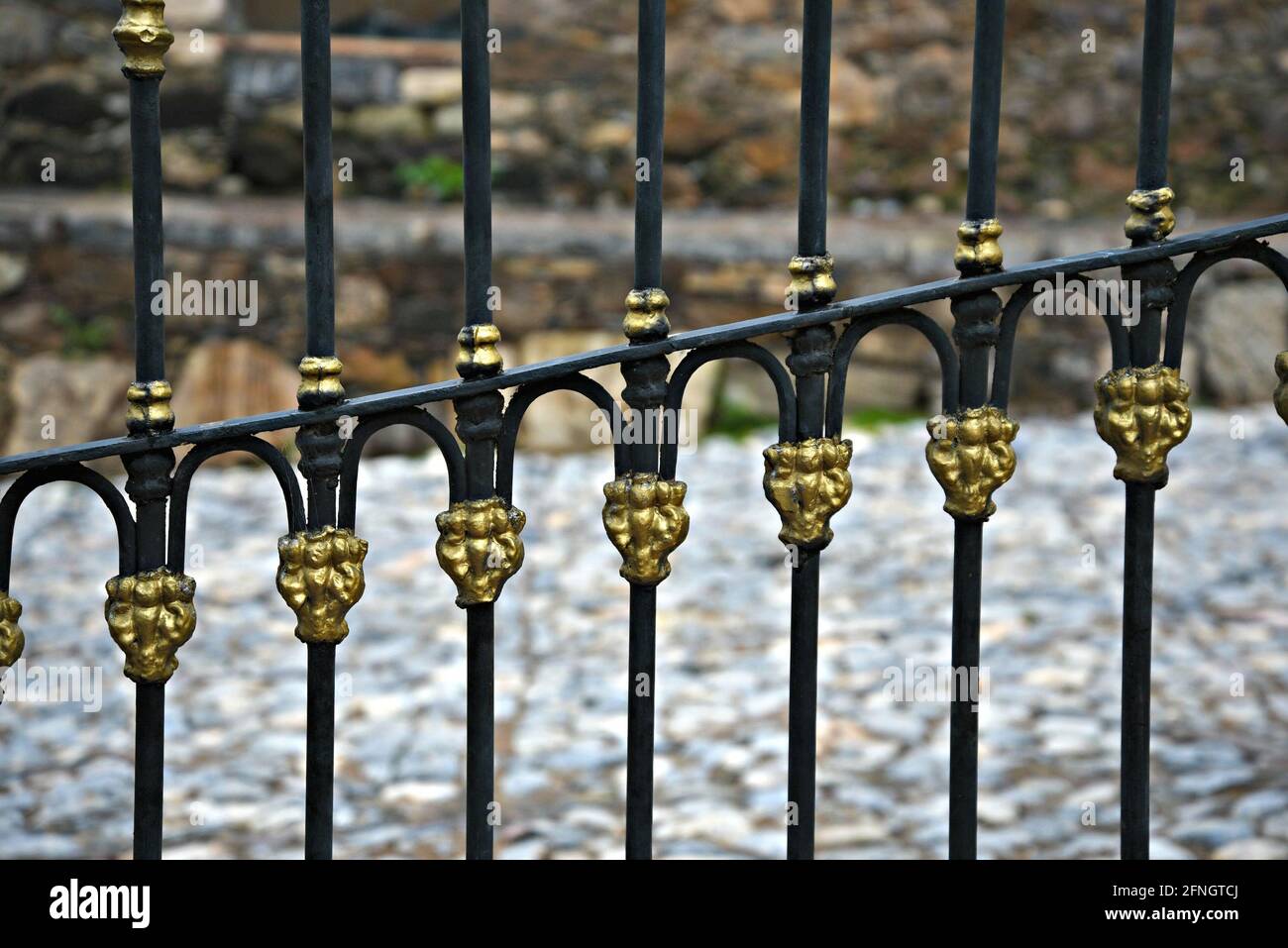 Close-up detail of a custom made gold and black wrought iron gate on ...