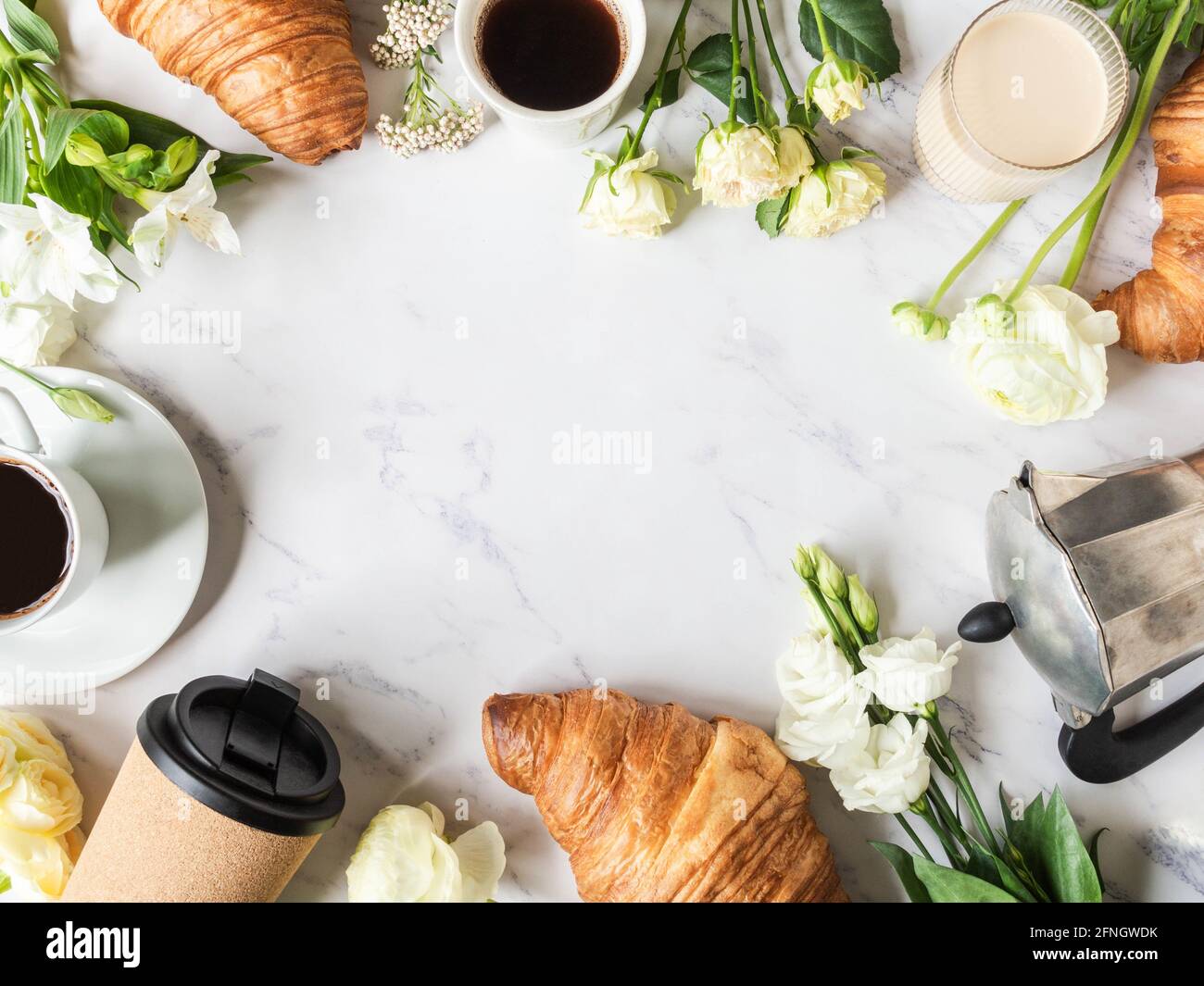 Flat lay frame of cups of coffee, flowers and croissant on marble ...
