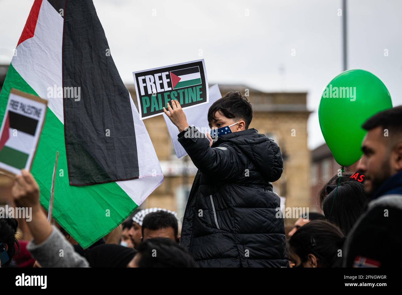 A kid holds a placard during the protest.Hundreds of people from across ...