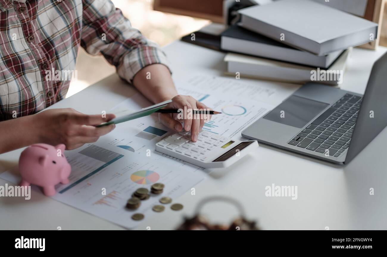 Woman calculating her Debt. woman hand calculating her monthly expenses ...