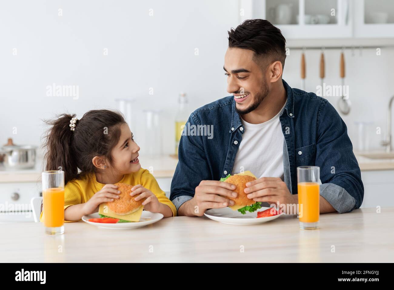 Lunch With Daddy. Cute Little Girl And Arab Dad Eating In Kitchen Stock ...