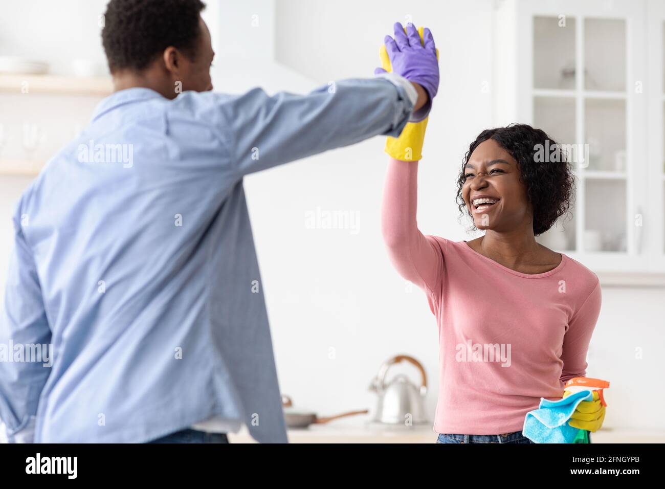 Happy african american house-keepers celebrating good job, kitchen ...