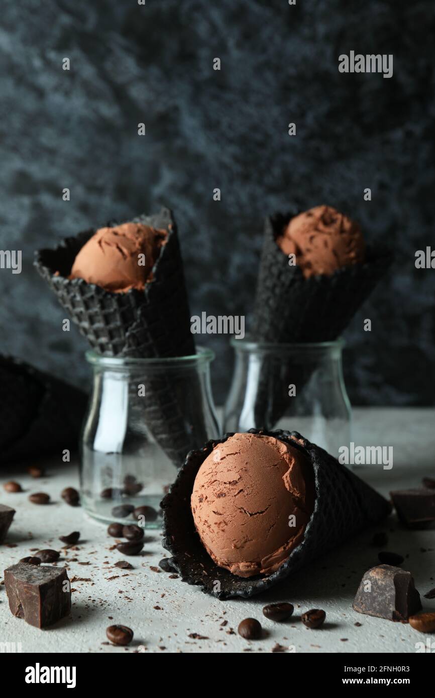 Black cones with ice cream against dark background Stock Photo - Alamy