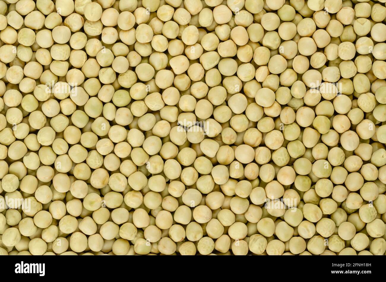 Dried whole peas, background, from above. Raw small spherical seeds of ...