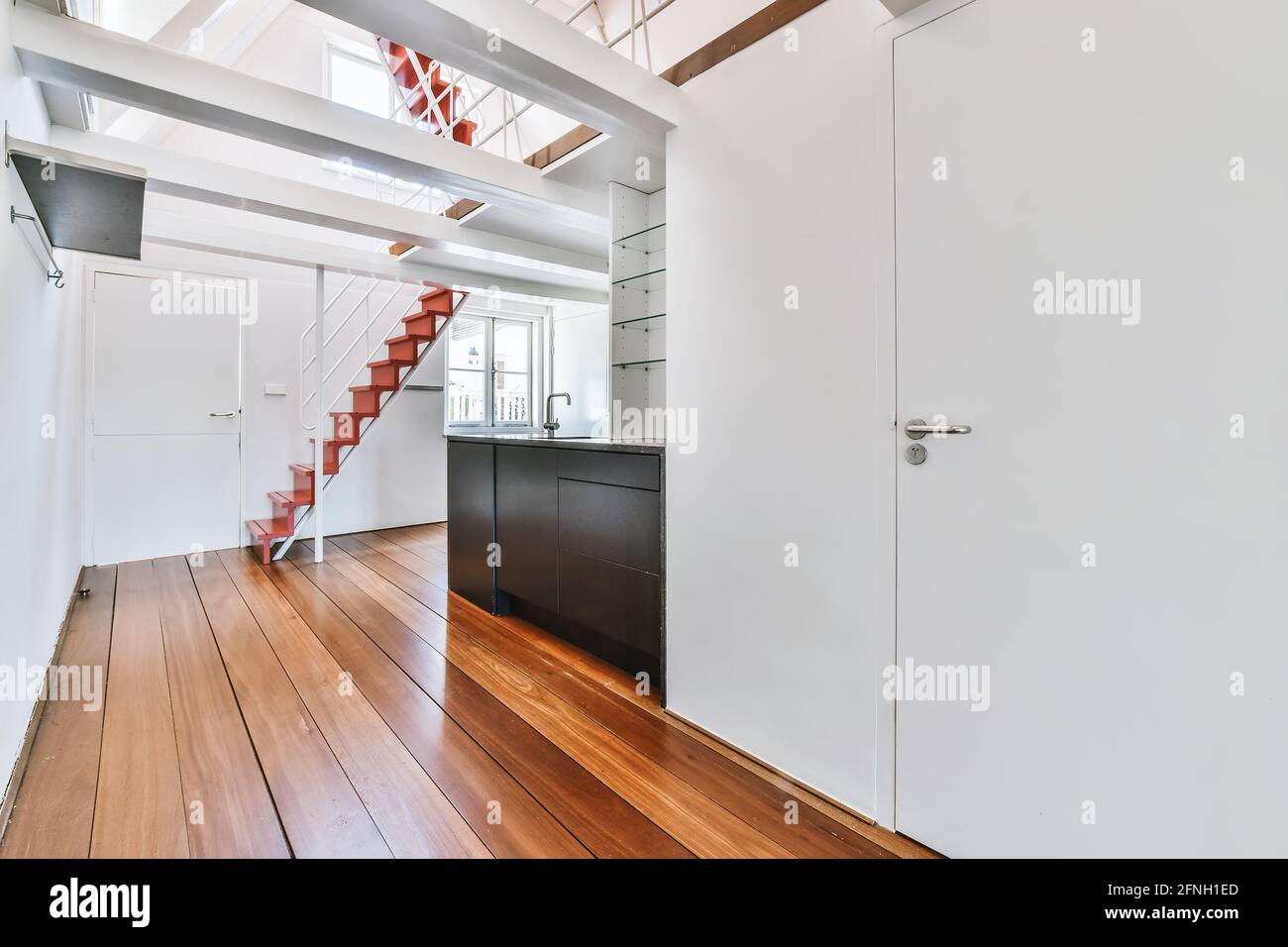 Empty kitchen near staircase in modern apartment Stock Photo - Alamy