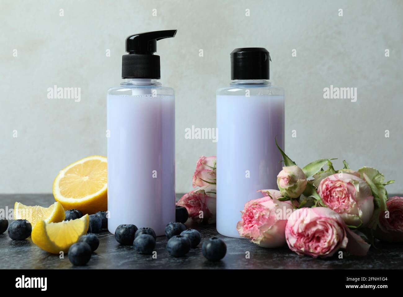 Natural shower gels and ingredients against white textured background ...