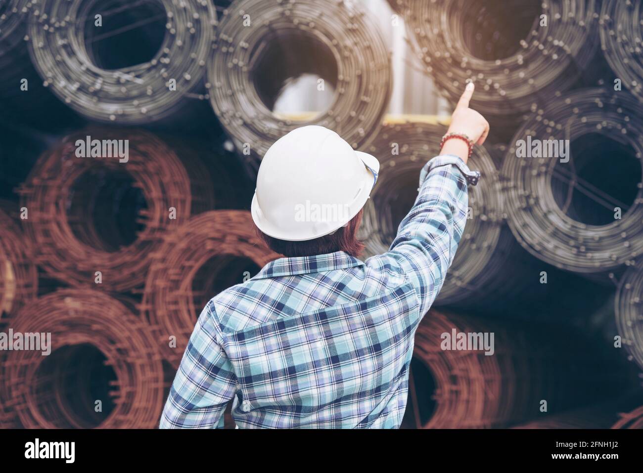 Woman engineering working on construction site and holding yellow hard ...