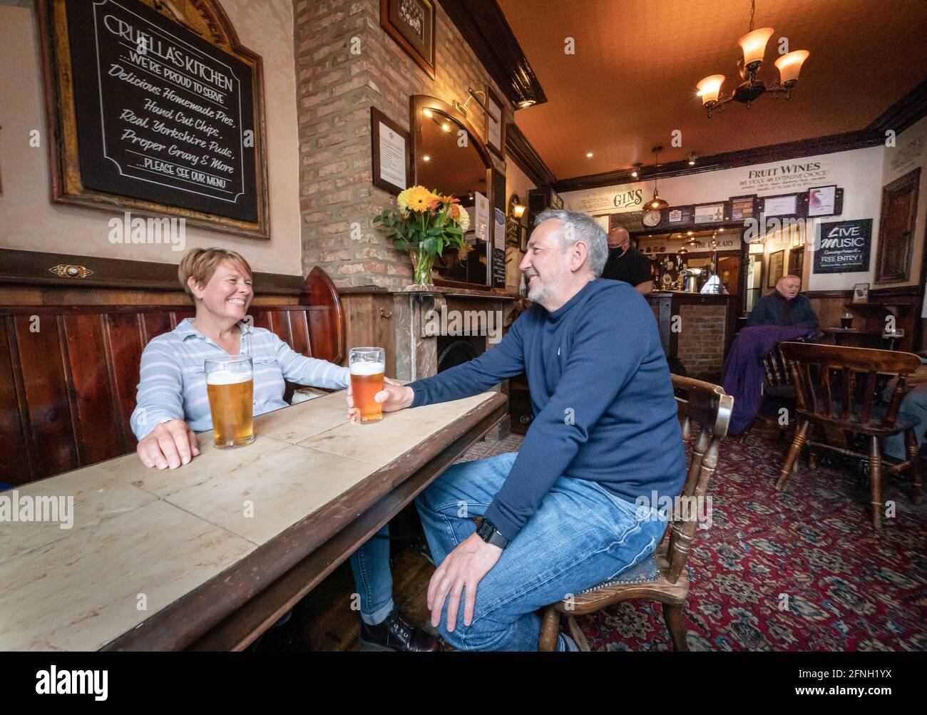 Sarah Meakin and Colin Bradshaw enjoy a pint at The Golden Slipper pub in York, as indoor ...