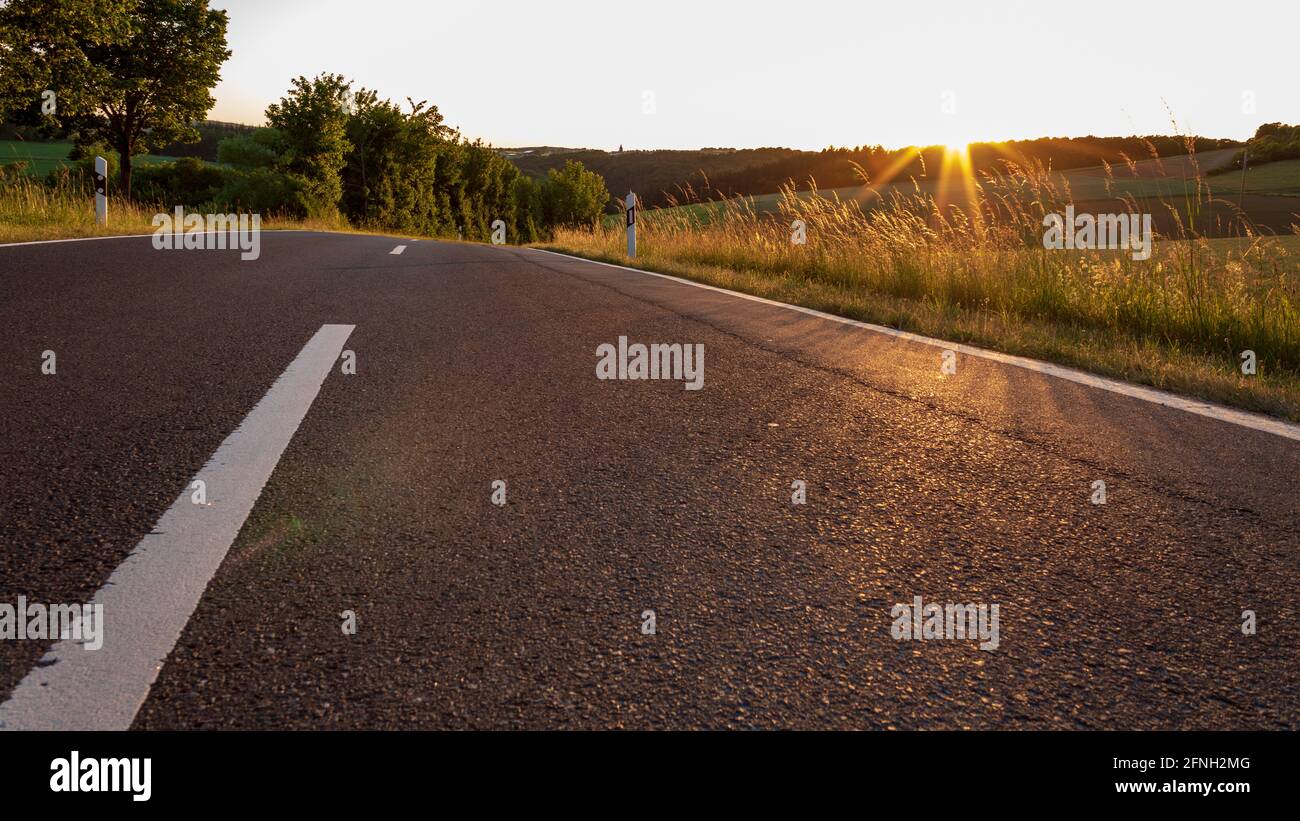Empty highway in the countryside at sunset in Werbach, Germany. Asphalt ...